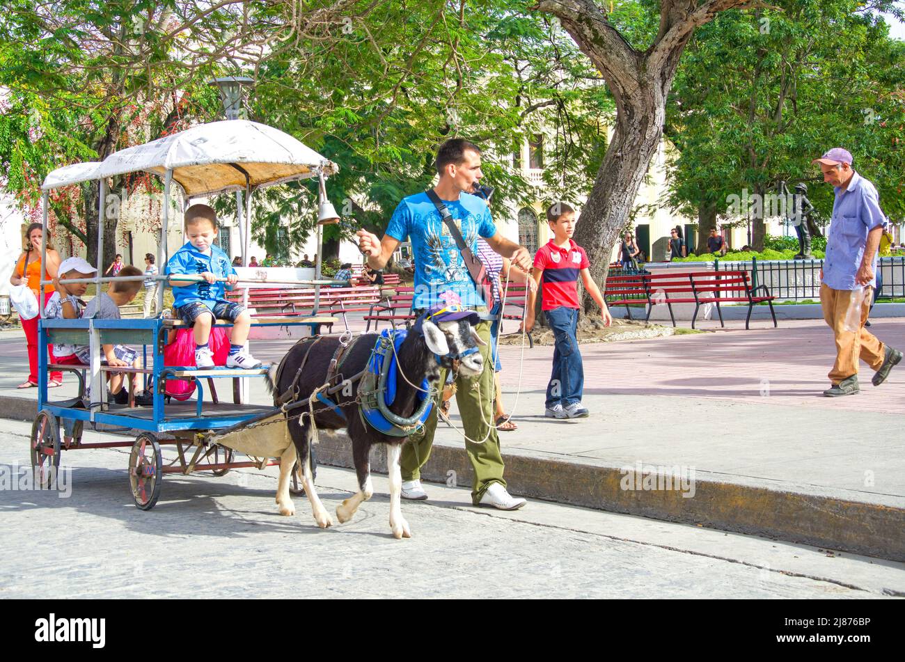 The goat ride in the Parque Leoncio Vidal. A self-employed man guides a ...