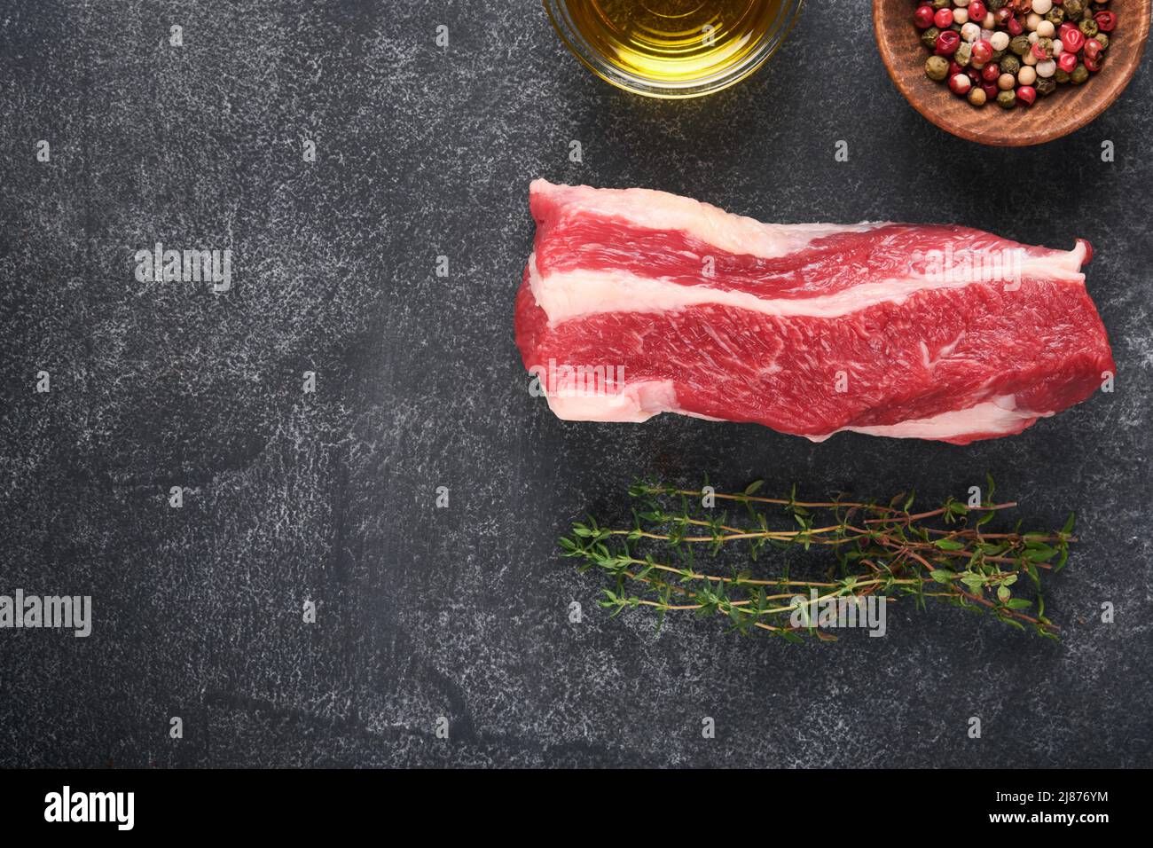 Steak beef. Raw steak New York with rosemary and spices on a piece of ...