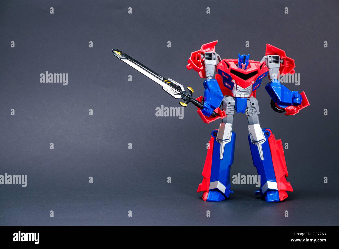 Robot transformer red and blue on black background with space for text ...