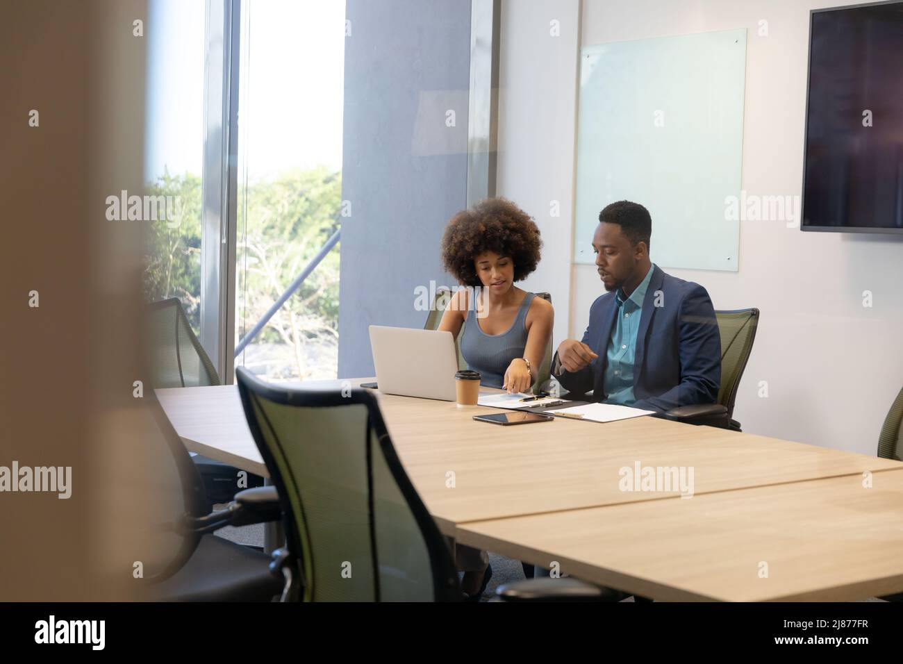 Multiracial young colleagues planning strategy in boardroom during ...