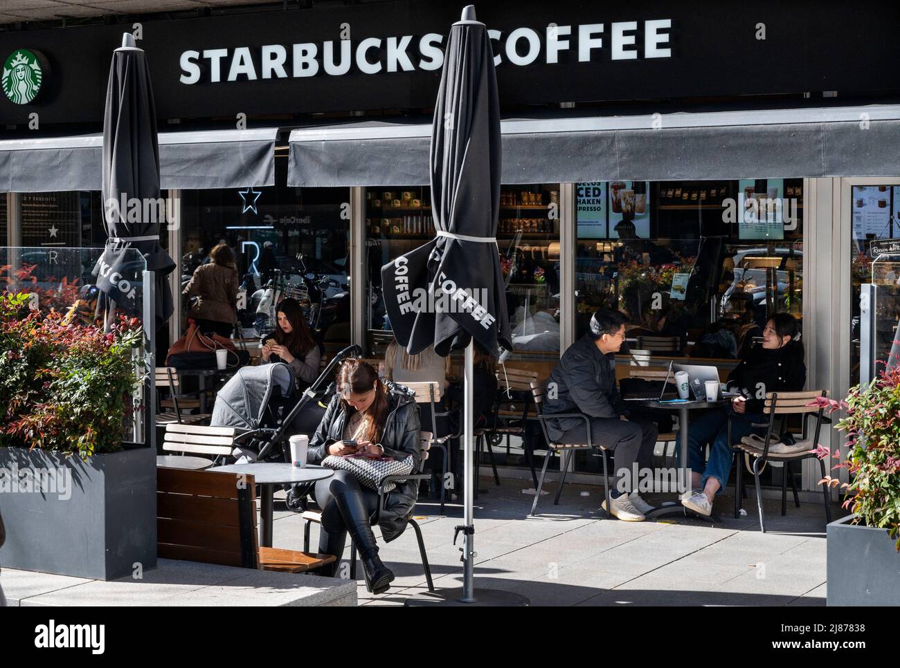 Customers are seen at the American multinational chain Starbucks Coffee ...