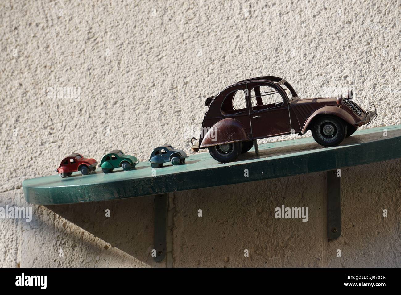 small family of 2CV citroen wood carvings on a shelf above a doorway in ...
