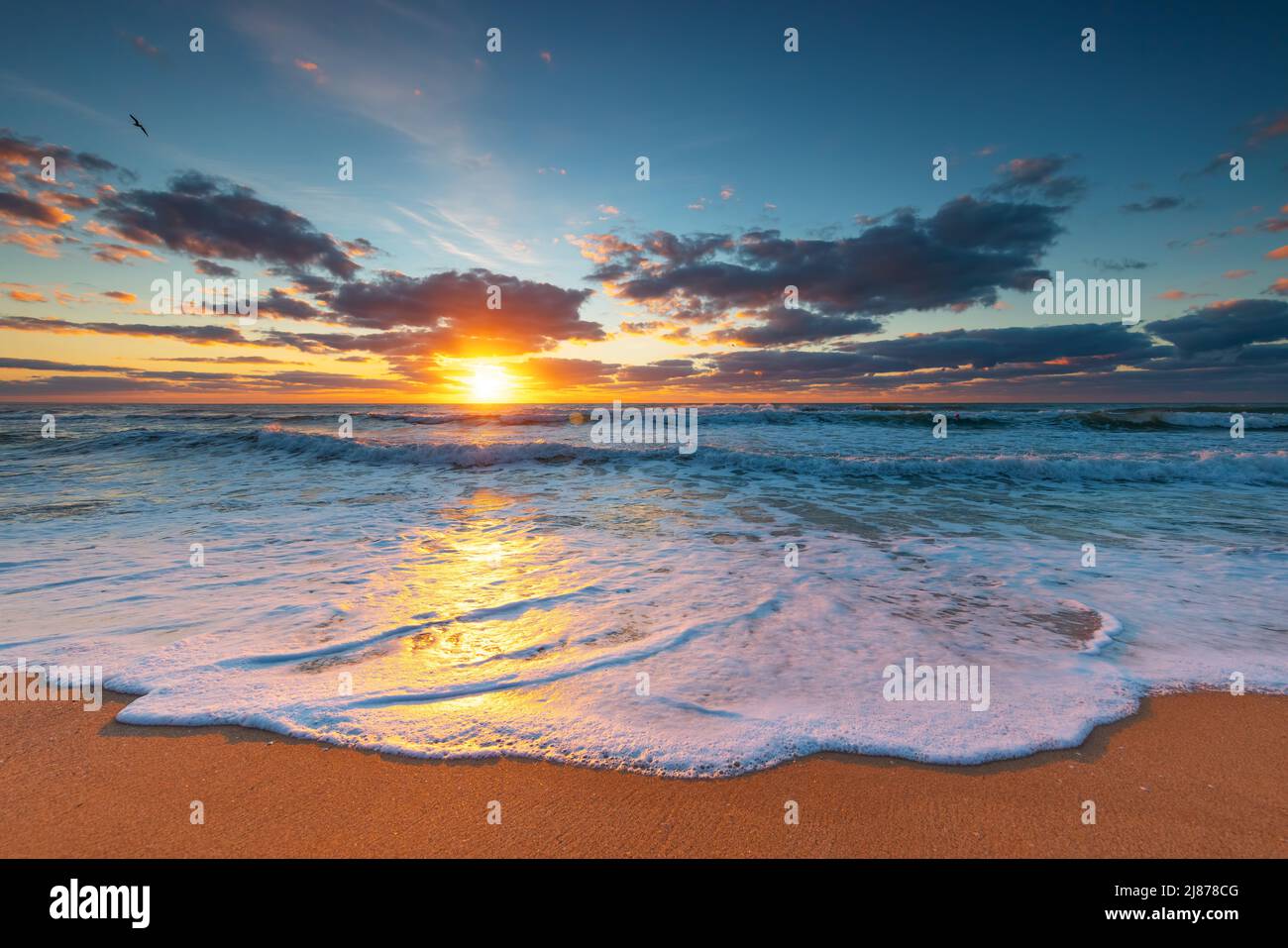 Sunrise at the beach with waves hi-res stock photography and images - Alamy