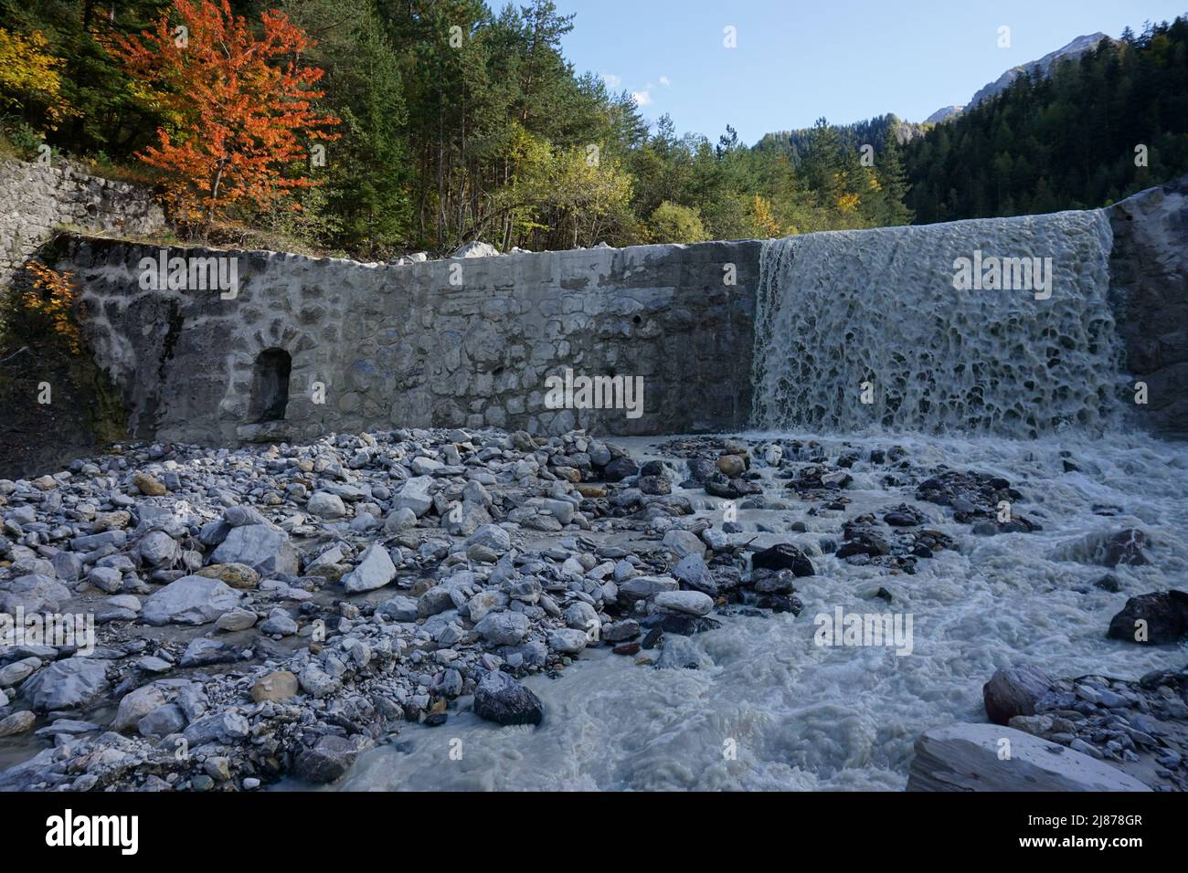 colorful fall trees and waterfall in Serre Ponçon, Southern Alps ...