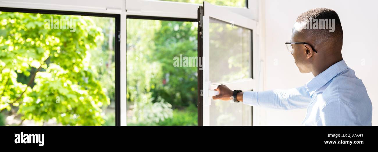 Man opening a window home hi-res stock photography and images - Alamy