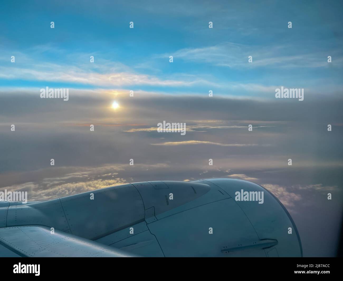 Beautiful clouds and sky at sunset as seen through window of an ...