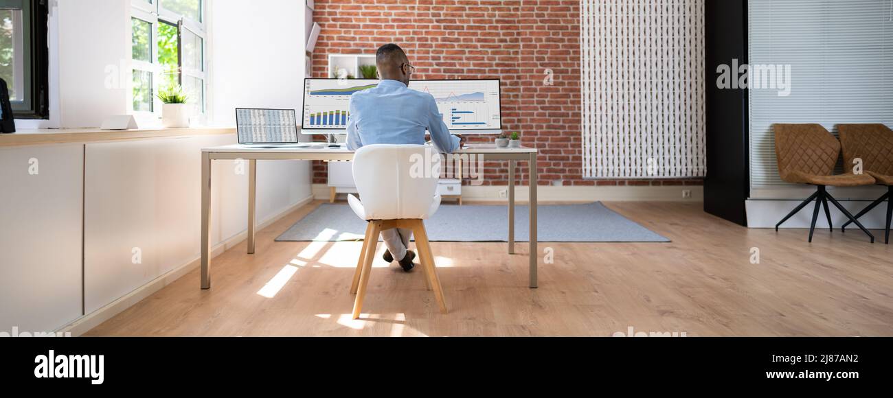Rear view of a man working on a computer hi-res stock photography and ...