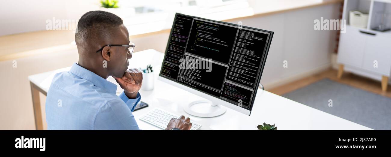 African American Coder Using Computer At Desk. Web Developer Stock Photo - Alamy