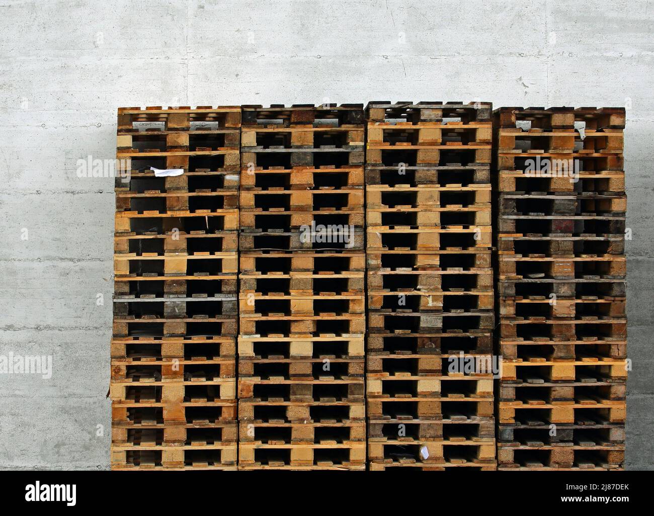 pile of wooden pallets piled up in the empty warehouse of a forwarding ...