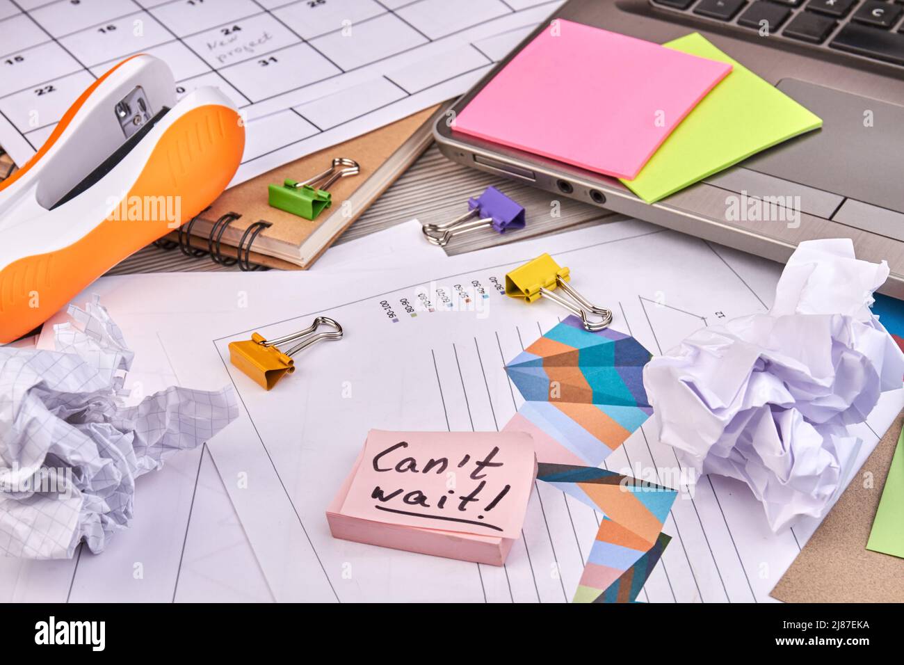 Close-up sticky notes with cant wait handwriting and office stuff. Work ...