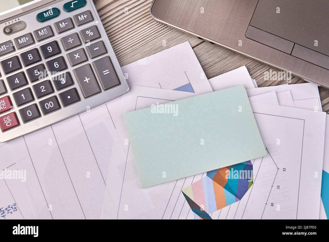 Blank paper for copy space with calculator and work papers. Top view ...