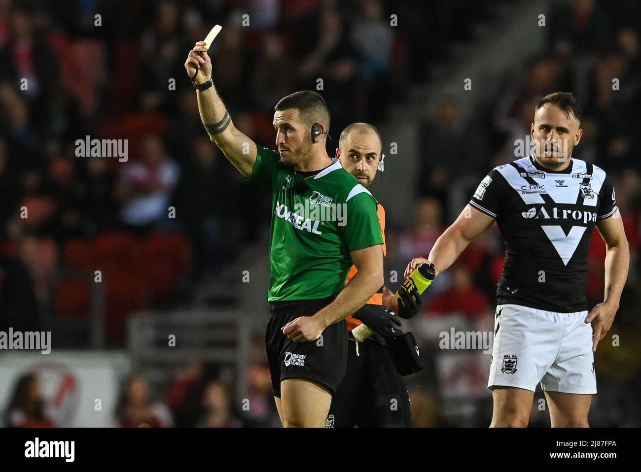 referee Jack Smith gives a yellow card to James Bell #20 of St Helens ...