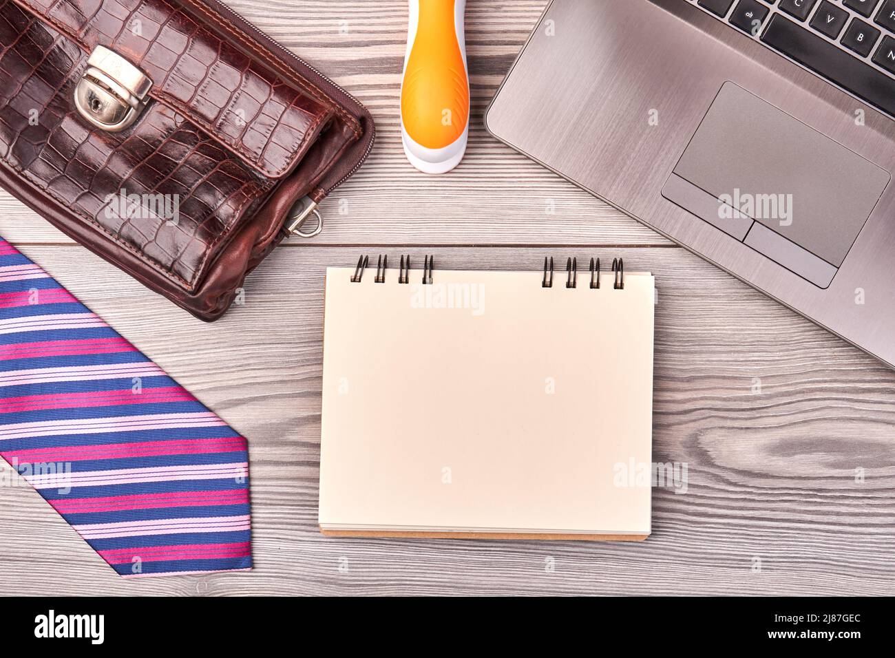 Notepad with handbag stapler and laptop pc. White desk background Stock ...