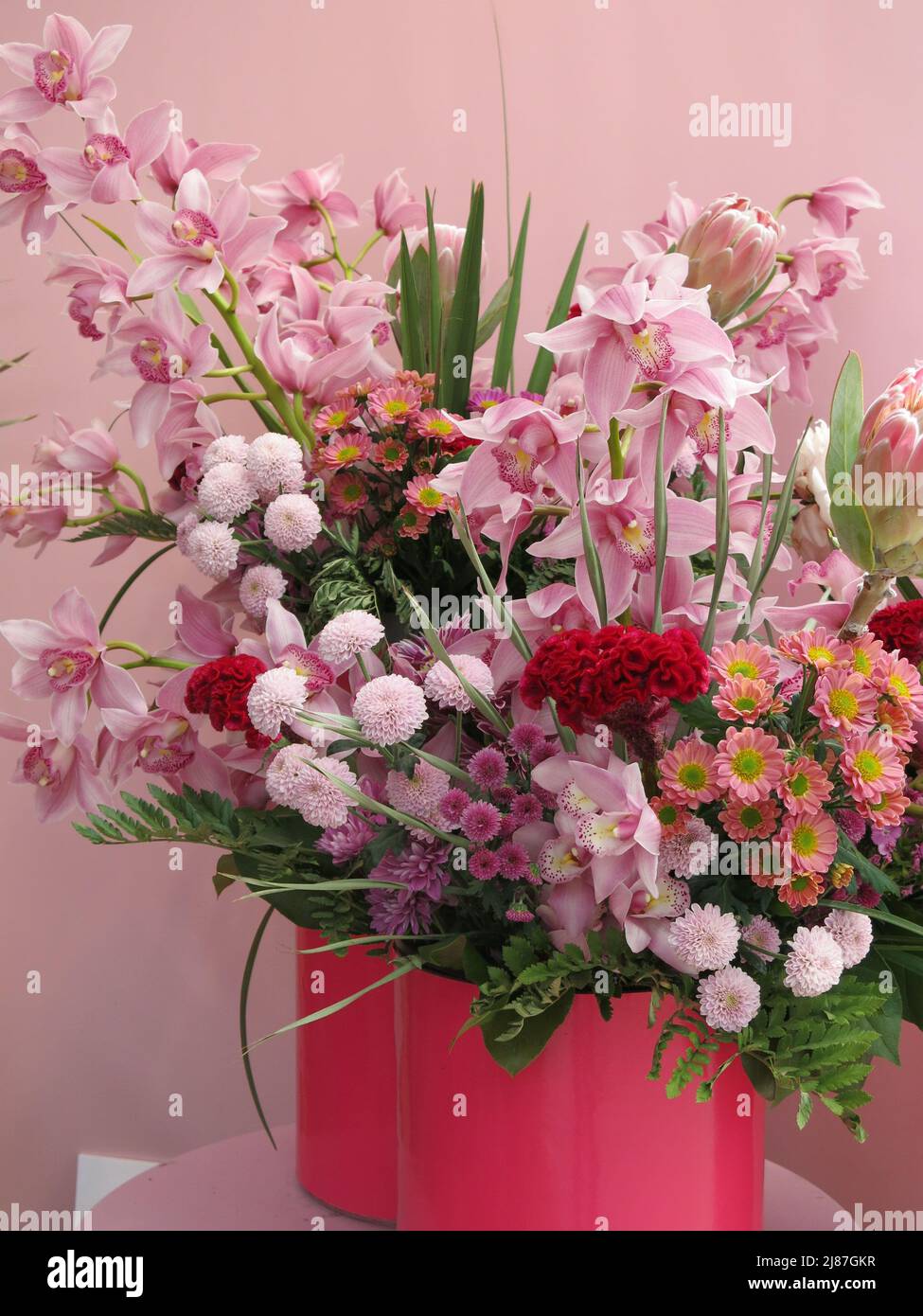 Exotic flower arrangement featuring romantic pink orchids amongst the ...
