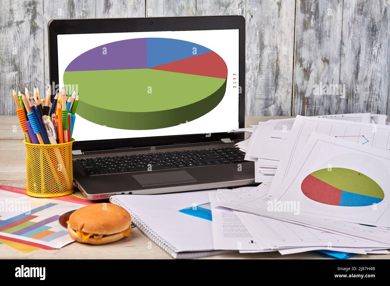 Office workplace with laptop papers and pens. Statistic diagrams for ...