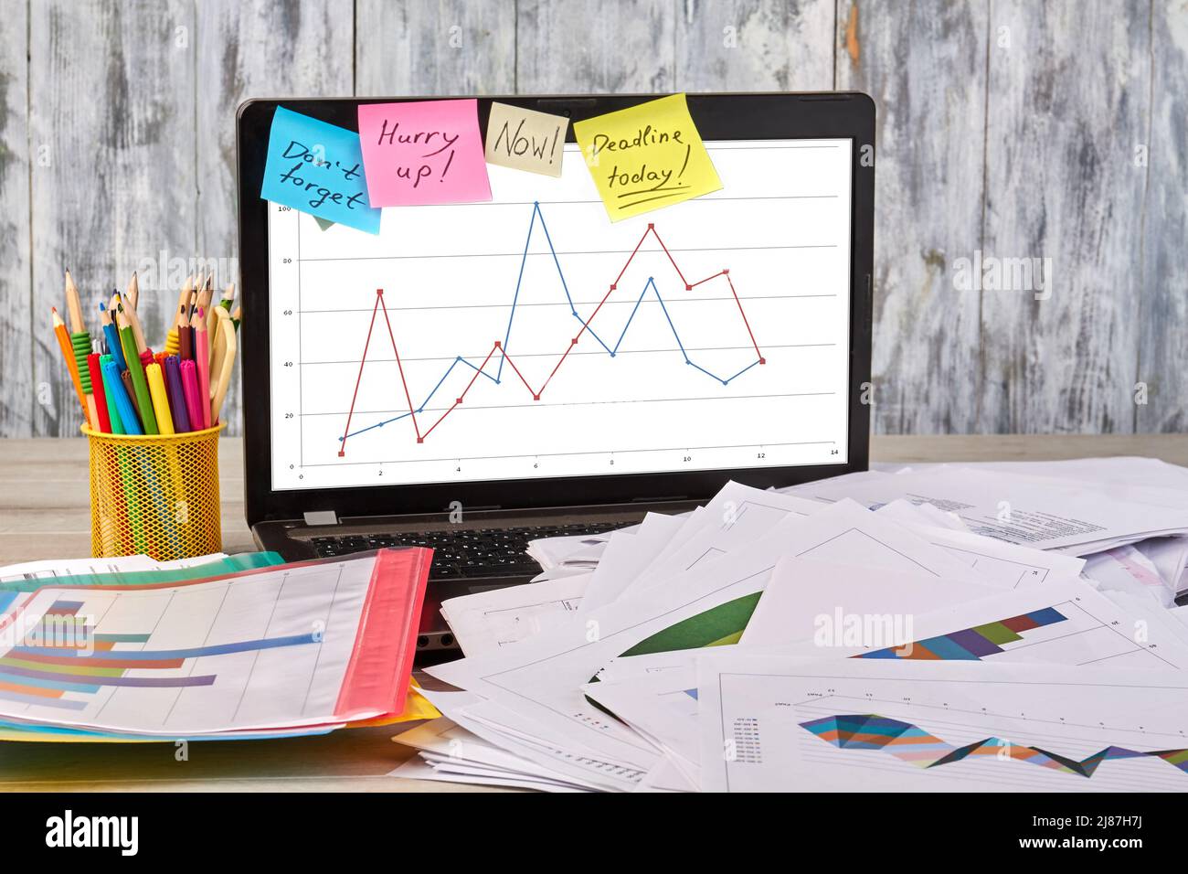 Office workplace with laptop and documents with statistic graphs ...