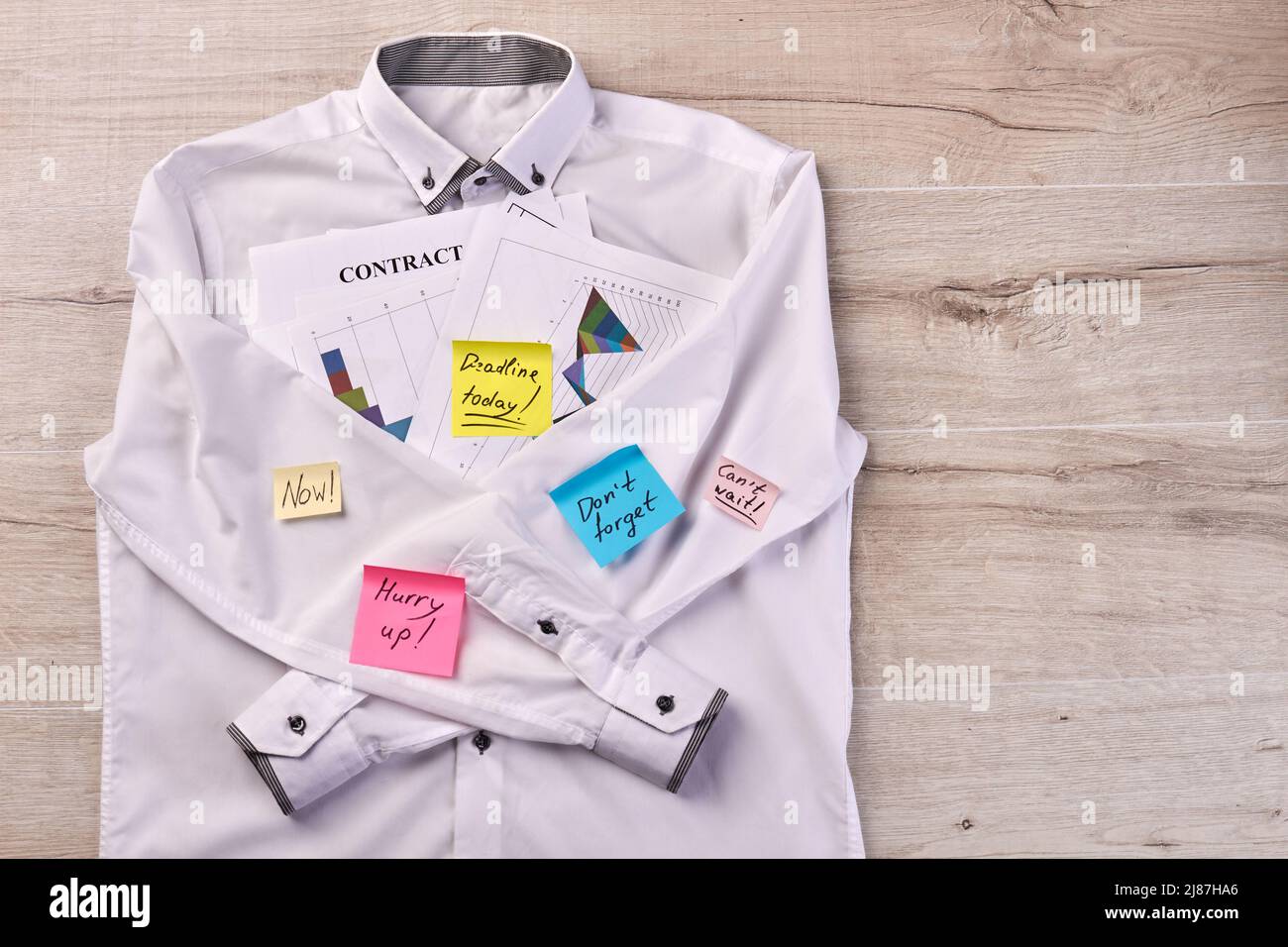 White shirt with sticky notes and business papers. Papers with ...