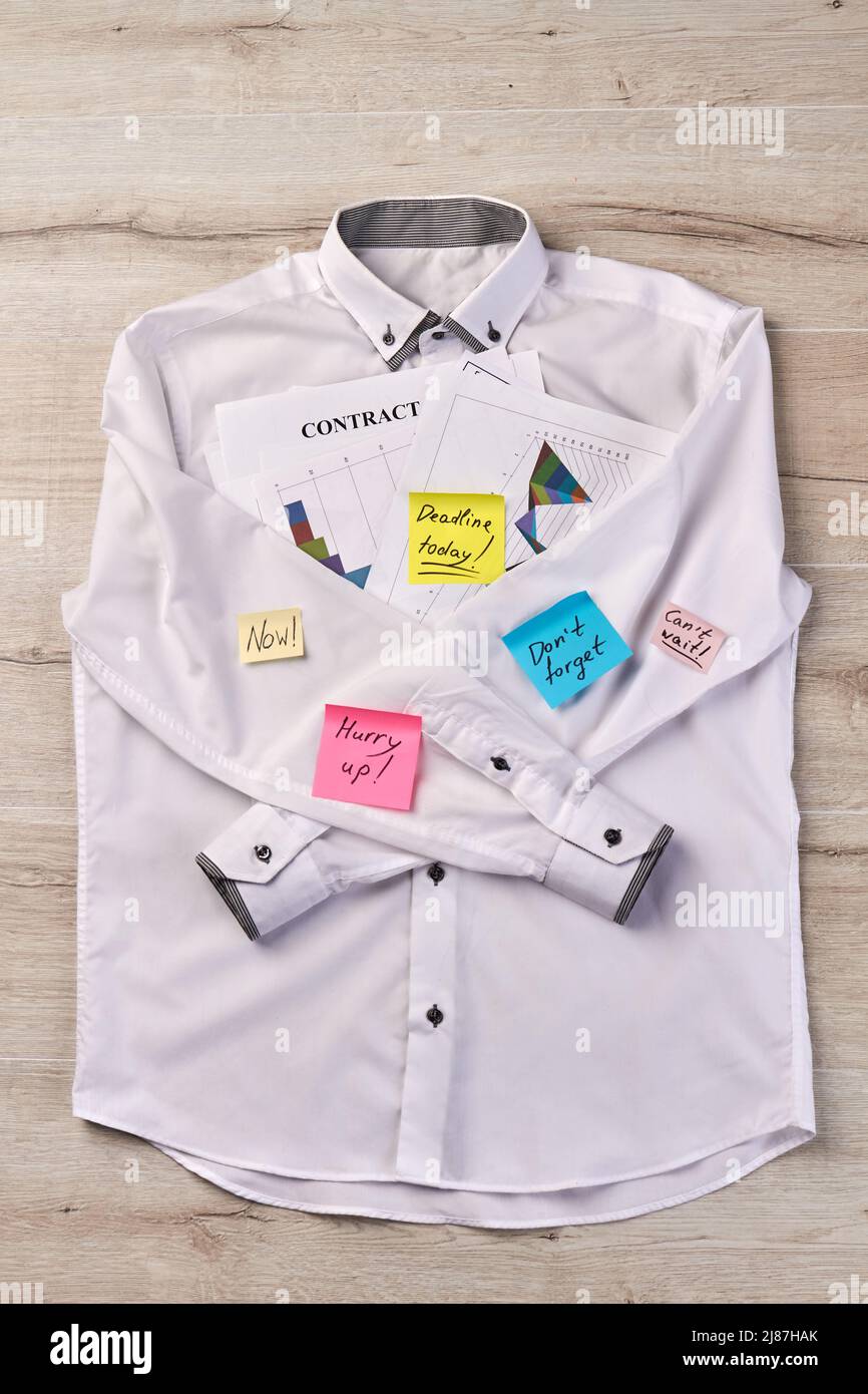 Vertical shot of white shirt with sticky notes. White desk background ...