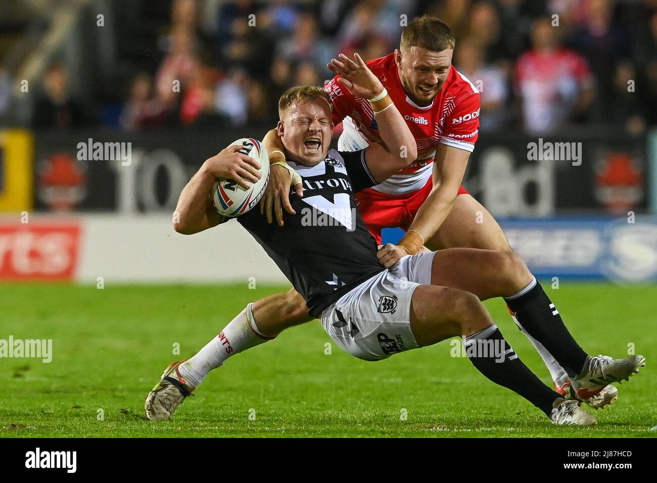 Jordan Johnstone (21) of Hull FC takes a high tackle from Joe Batchelor ... Jordan Johnstone (21) of Hull FC takes a high tackle from Joe Batchelor ...