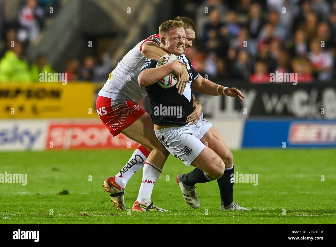 Jordan Johnstone (21) of Hull FC takes a high tackle from Joe Batchelor ... Jordan Johnstone (21) of Hull FC takes a high tackle from Joe Batchelor ...