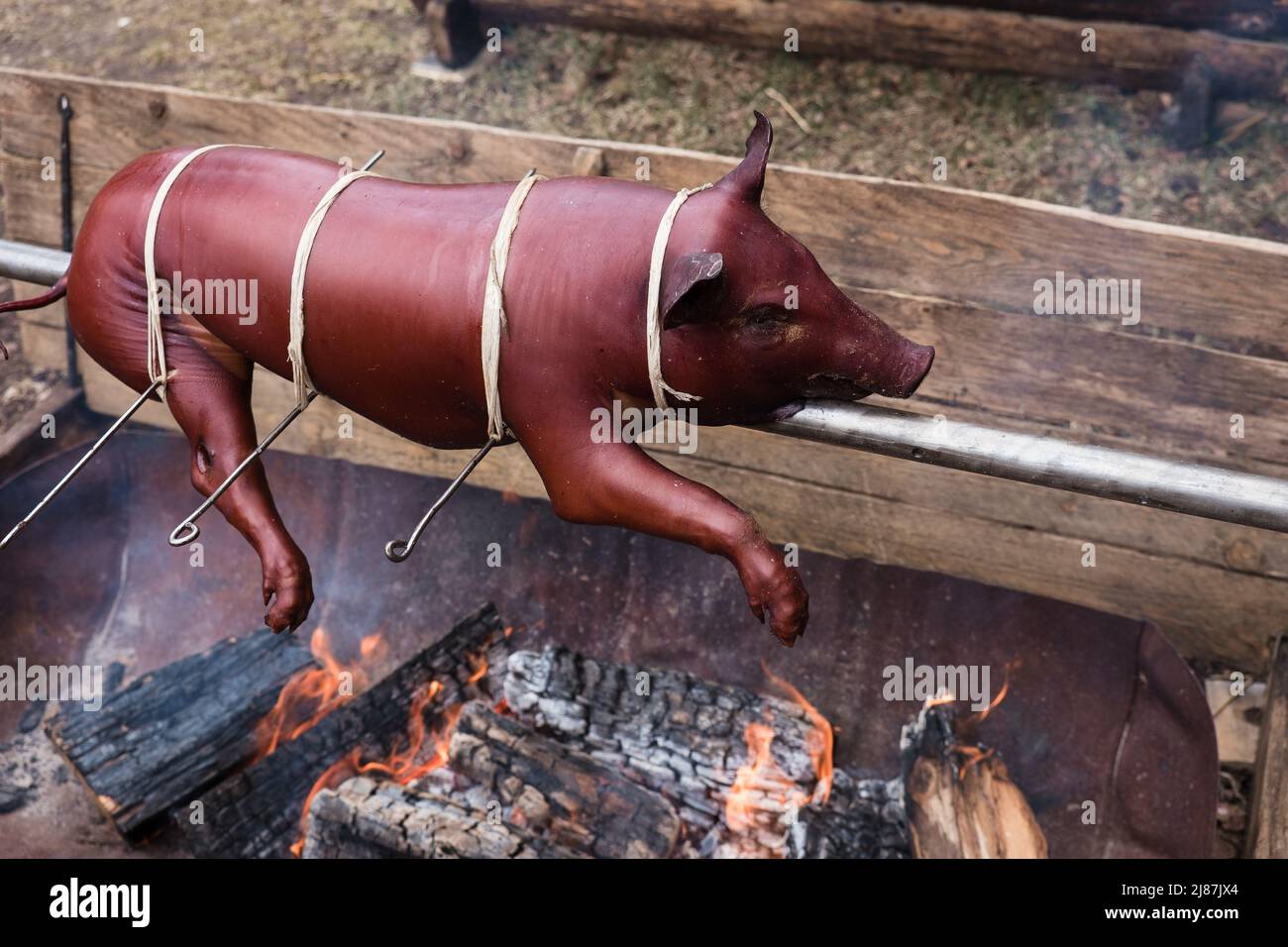 Piglet on grill, roasting pork. Cooking a whole small pig on fire Stock ...