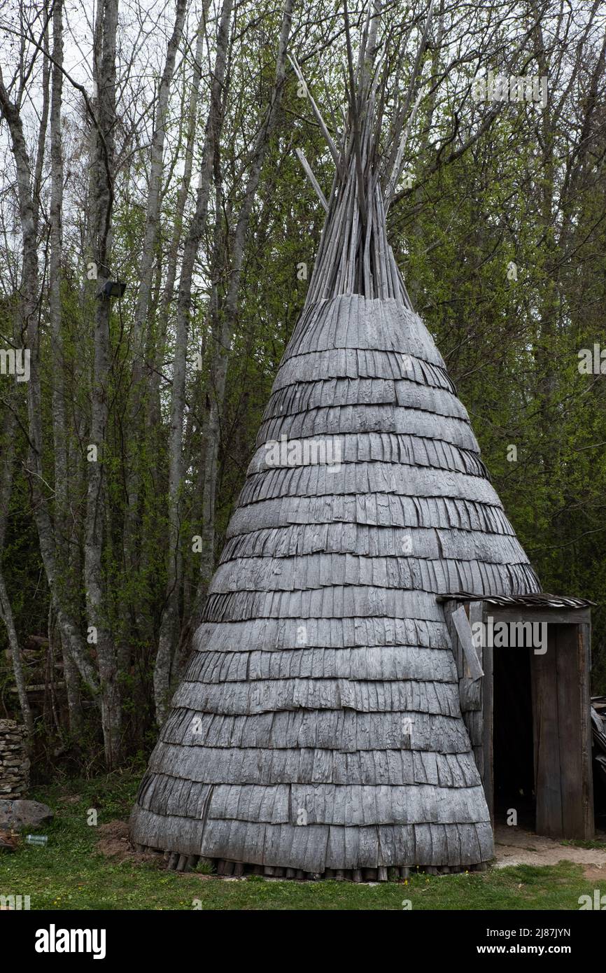 Conical light wooden medieval building with fireplace in the middle ...