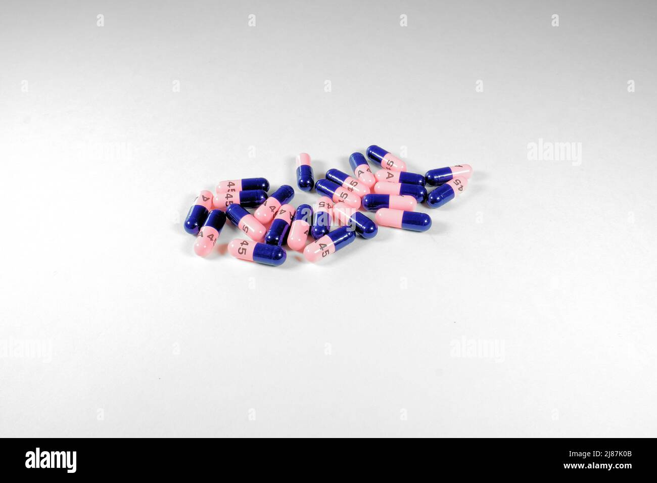 Amoxicillin capsules on a white background; antibiotic used to treat ...