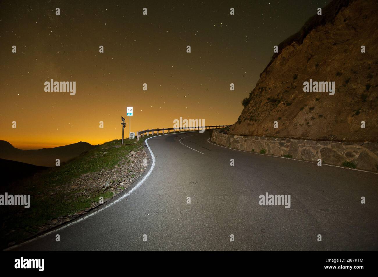 Curve in the mountain road at night Stock Photo - Alamy