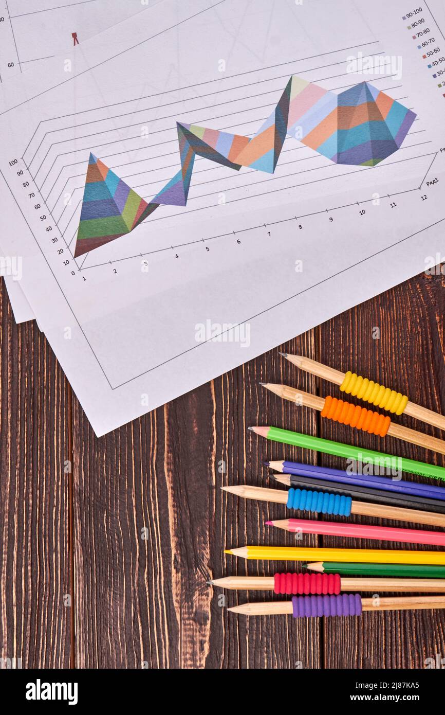 Top view set of pencils and work papers. Brown wood background Stock ...