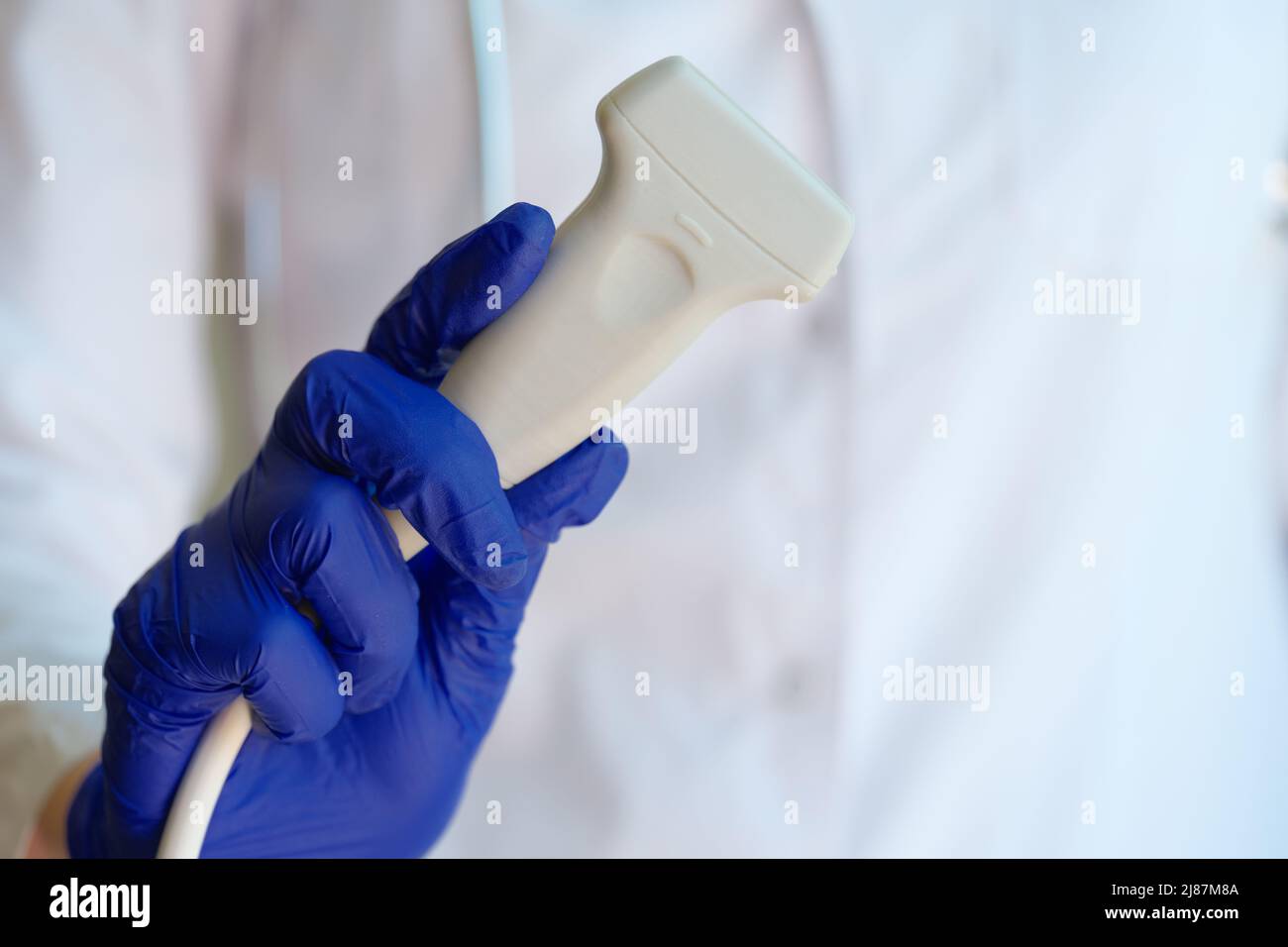 Doctor holds in hand ultrasound probe ultrasound machine Stock Photo ...