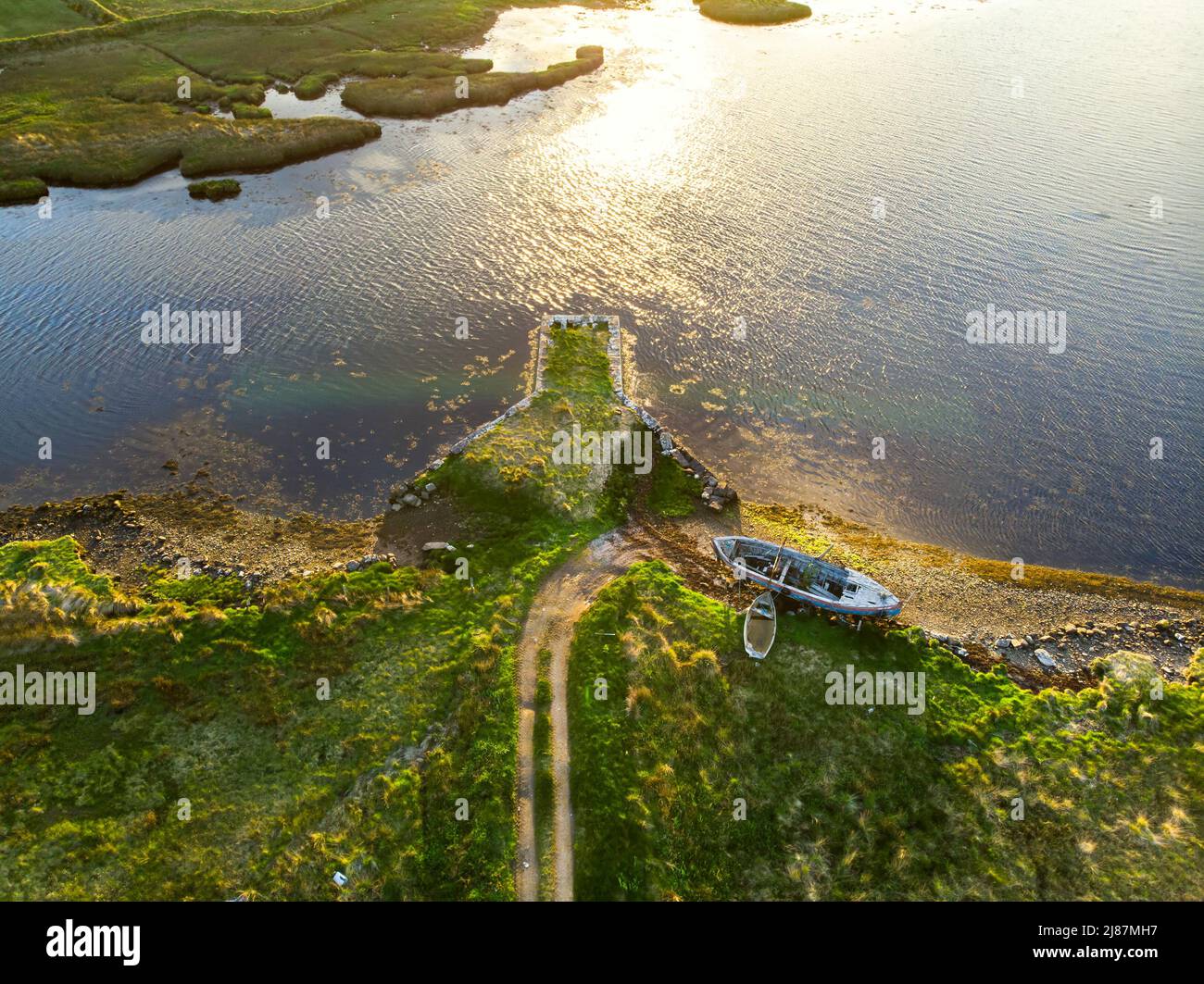 Aerial view of old boat left on a small beach along the Ring of Kerry ...