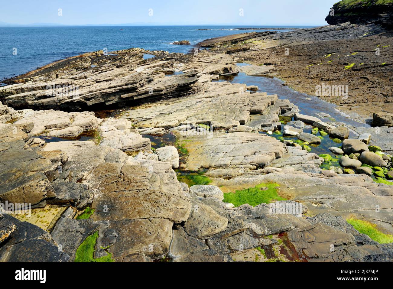 Rough and rocky shore along famous Ring of Kerry route. Rugged coast of ...
