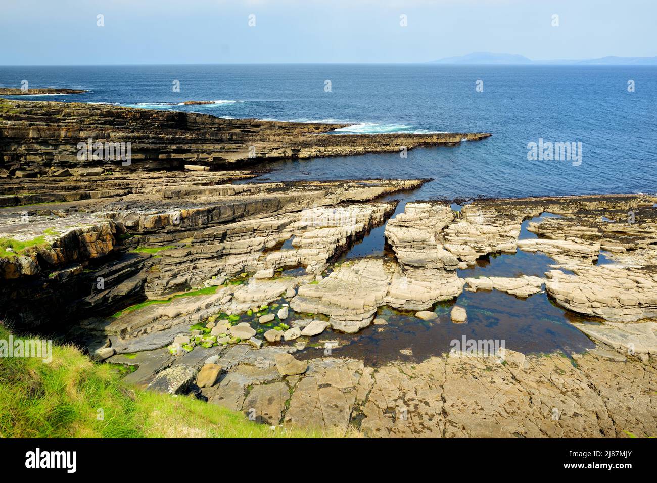 Rough and rocky shore along famous Ring of Kerry route. Rugged coast of ...