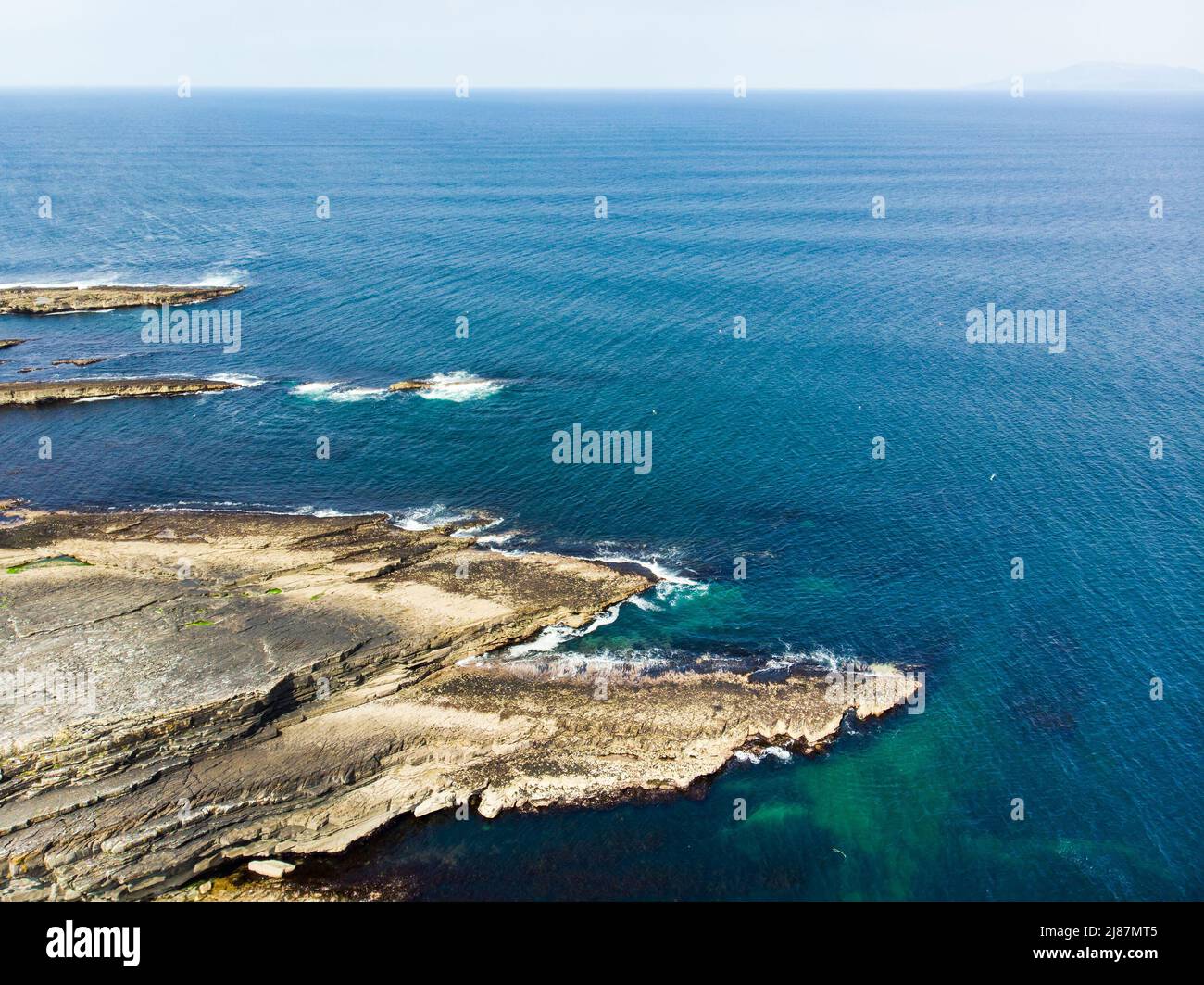 Rough and rocky shore along famous Ring of Kerry route. Rugged coast of ...