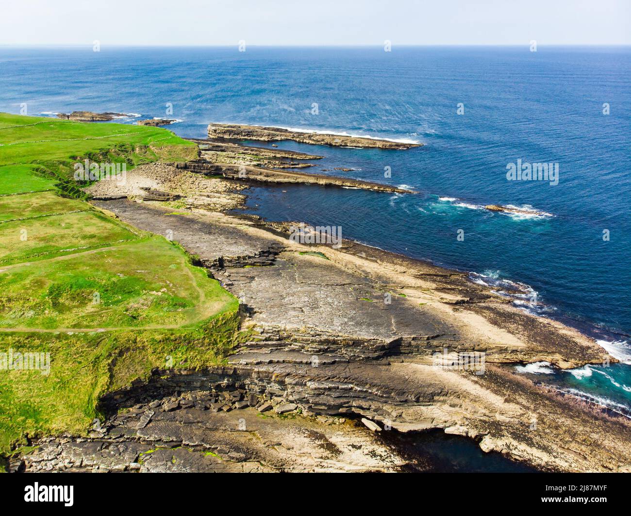 Rough and rocky shore along famous Ring of Kerry route. Rugged coast of ...