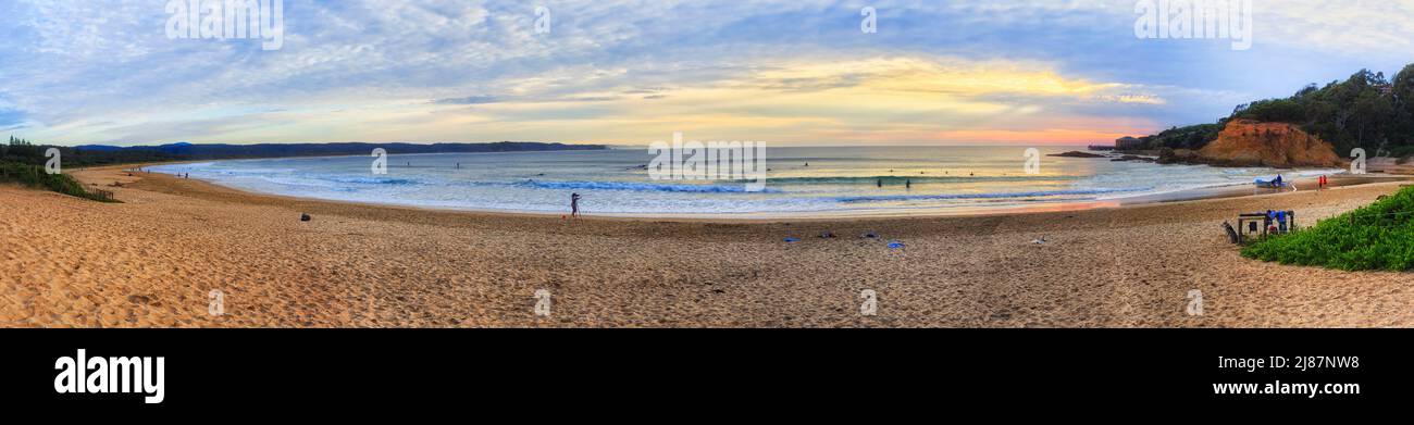 Popular pristine sandy beach in Tathra town with historic wharf on ...