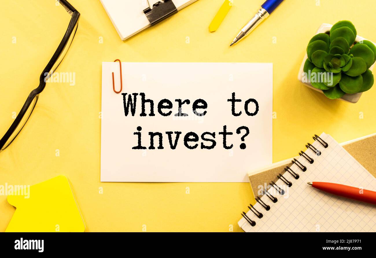 Hand writing the text: Where to Invest Stock Photo - Alamy