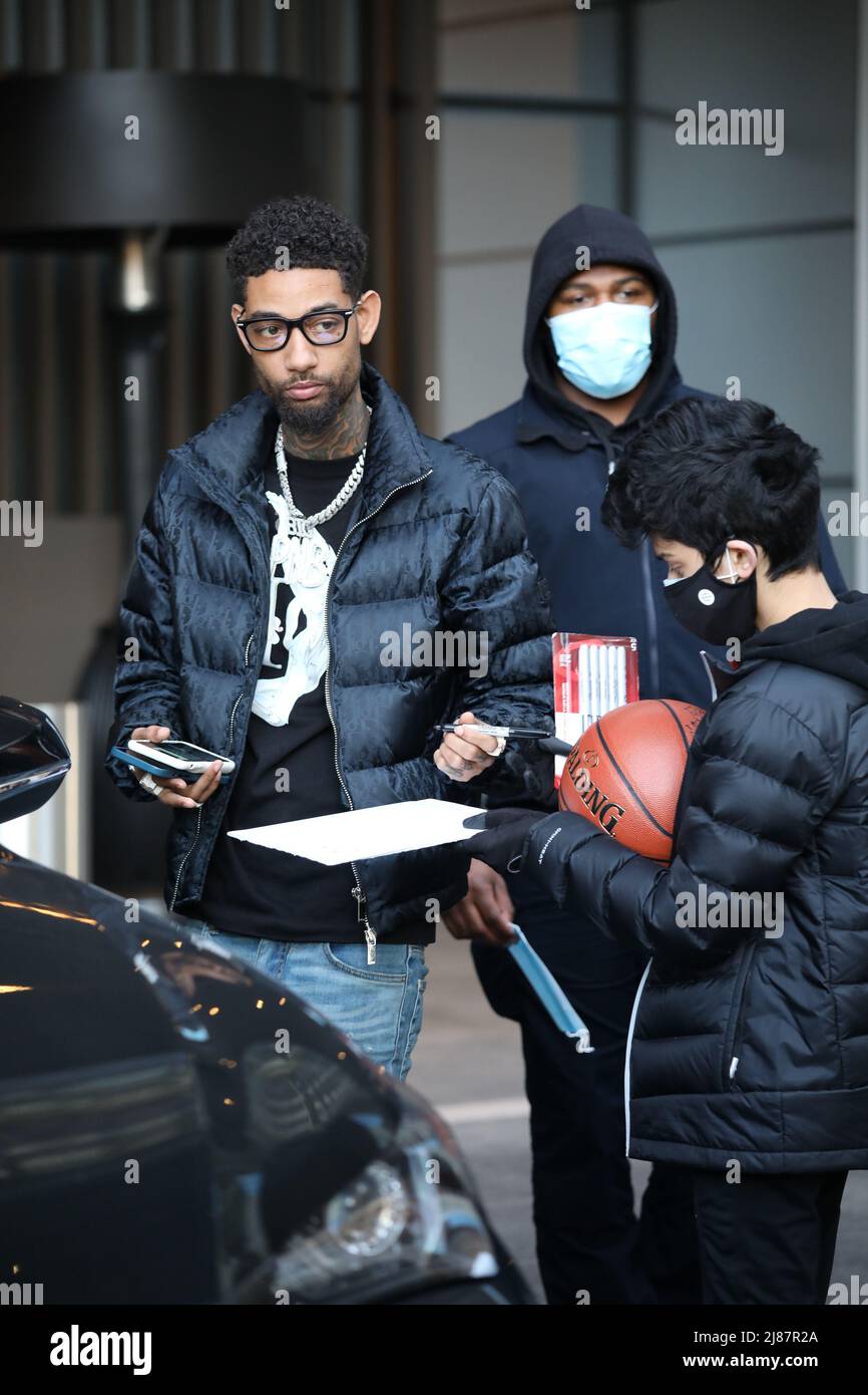 Rapper PnB Rock signs an autograph for a fan before he enters the Four ...