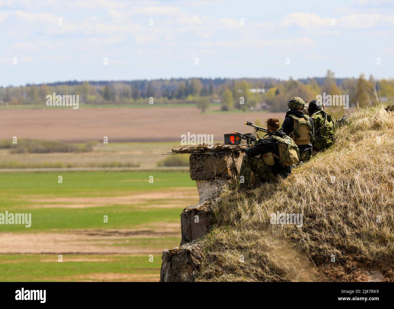 Canadian soldiers place themselves strategically throughout the ...