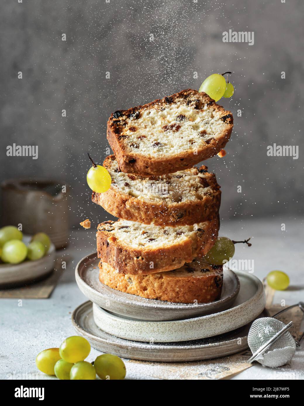 Delicious homemade fruit cake with raisins in levitation with crumbling ...