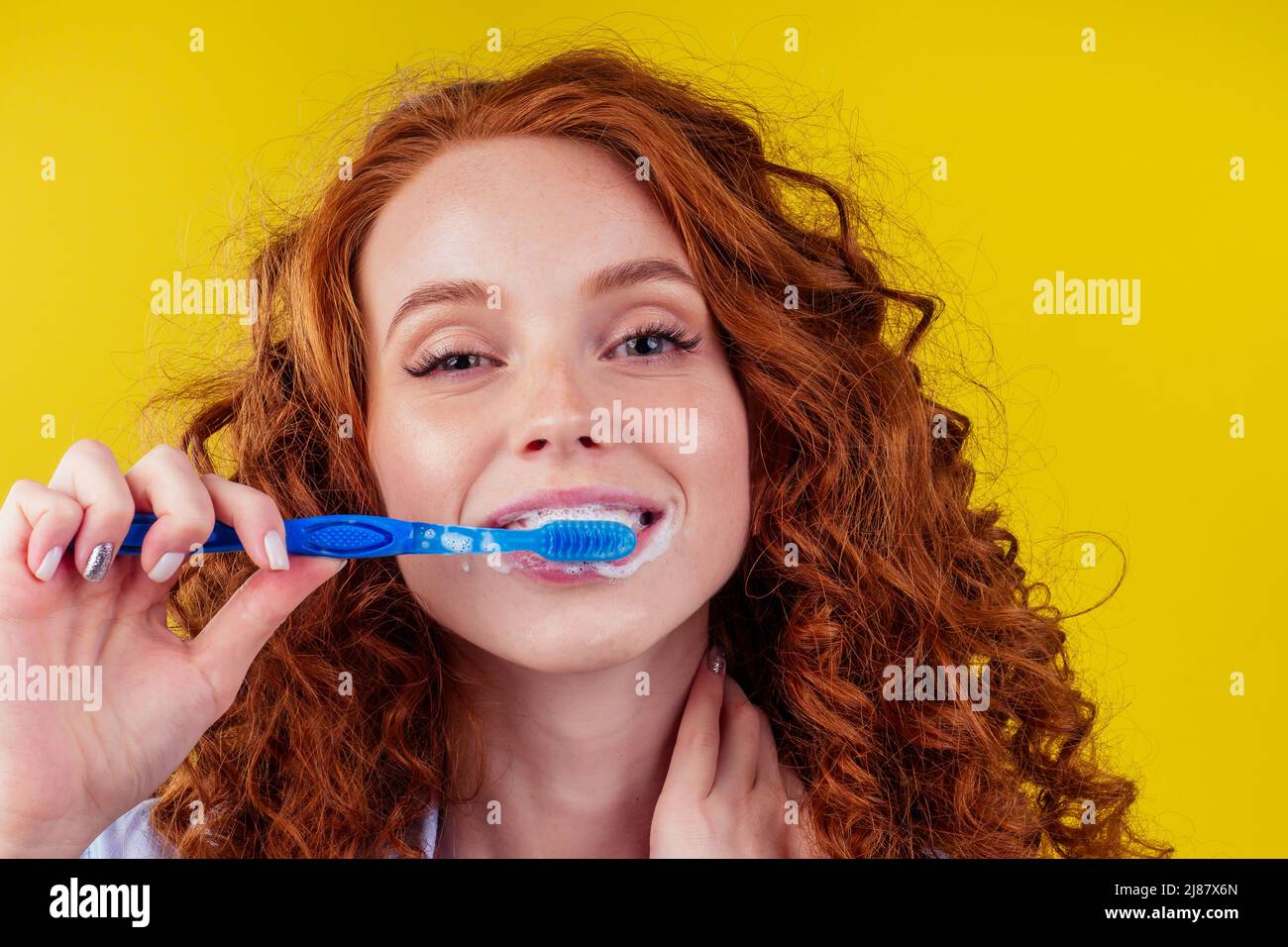 sleepy redhaired ginger woman brushing teeth with toothpaste eco paste ...