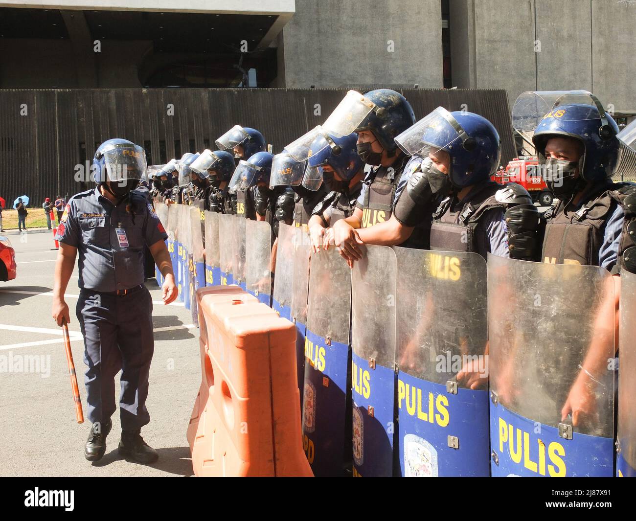 Members of the Civil Disturbance Management (CDM) Unit stand on guard ...