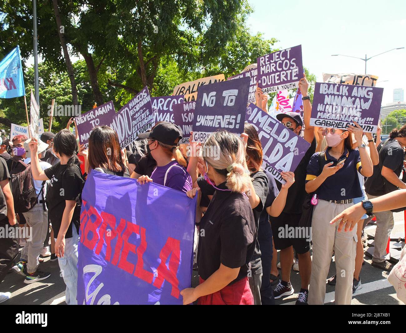 GABRIELA women's group organization hold a banner and placards ...
