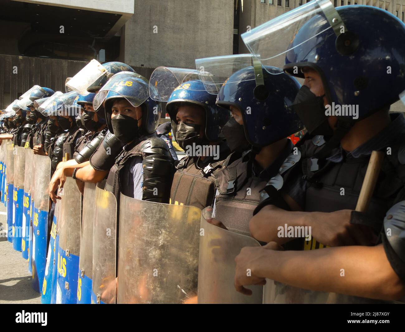 Members of the Civil Disturbance Management (CDM) Unit stand on guard ...