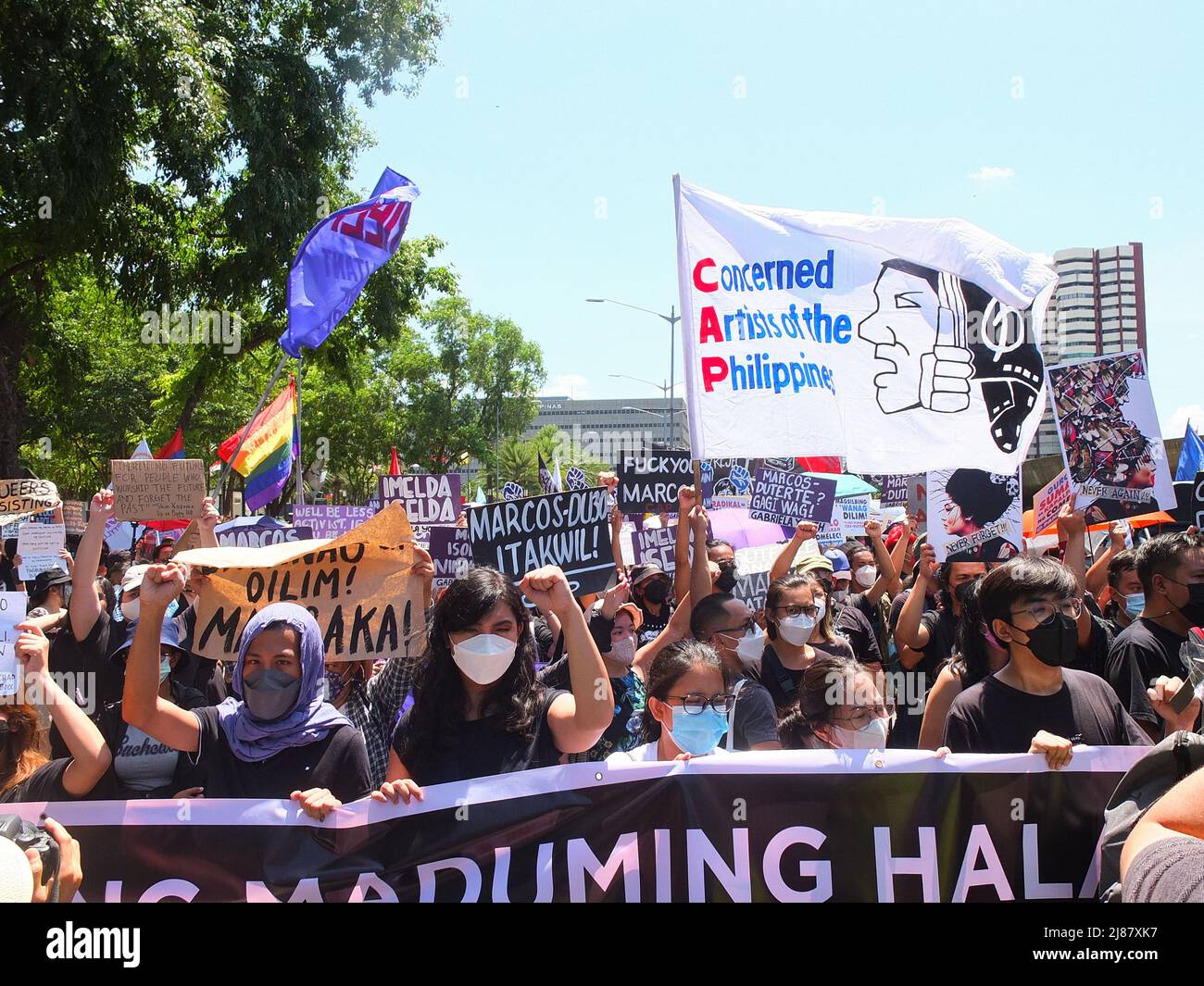 Different youth group protesters raise their fists while chanting about ...