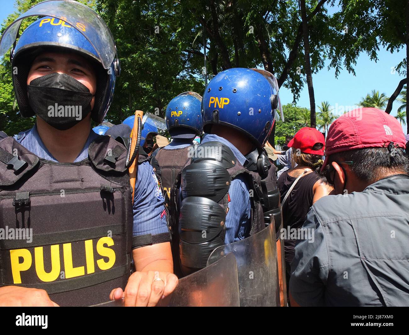 Members of the Civil Disturbance Management (CDM) Unit stand on guard ...