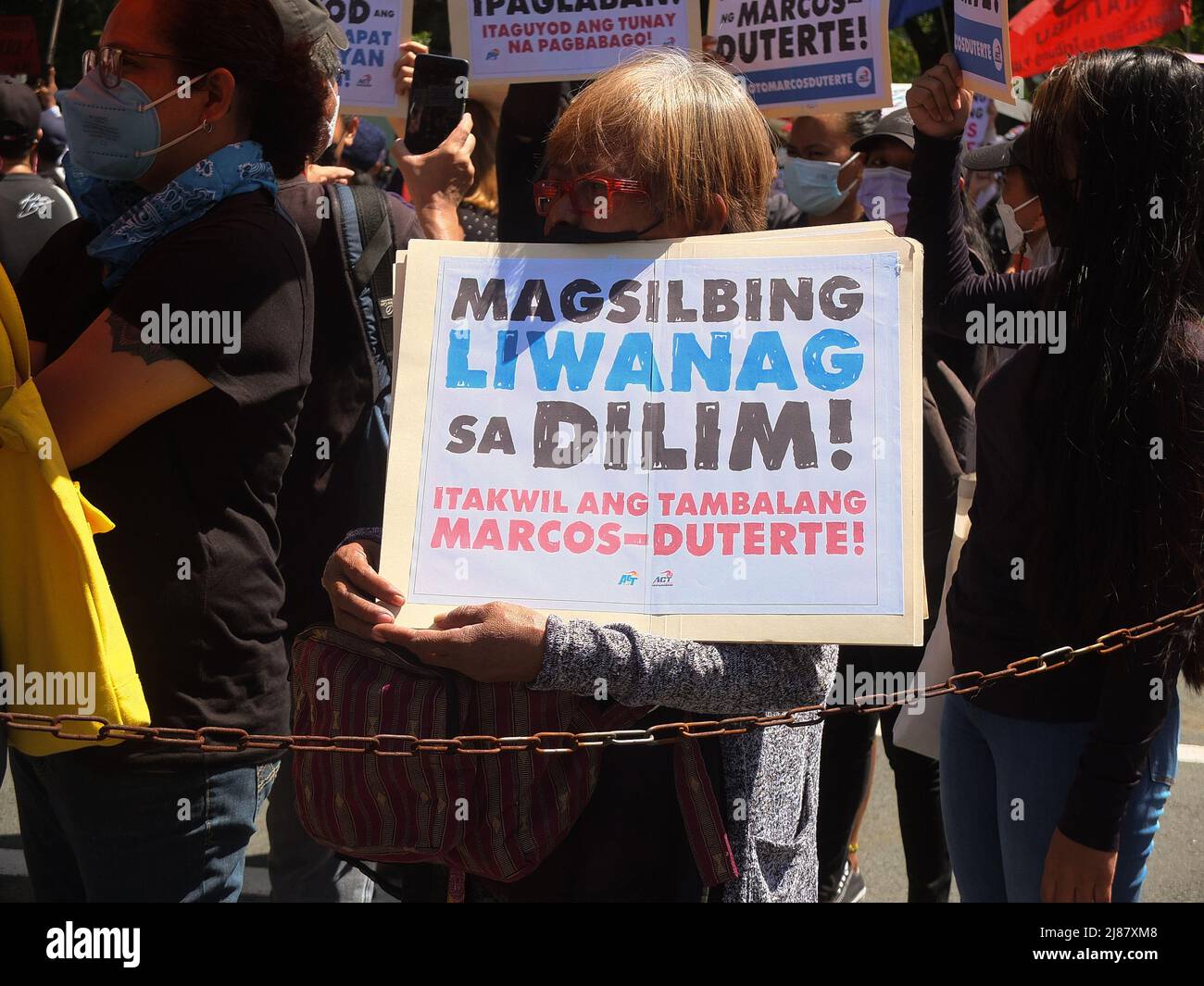 A protester holds a placard with a message that every citizen must be ...