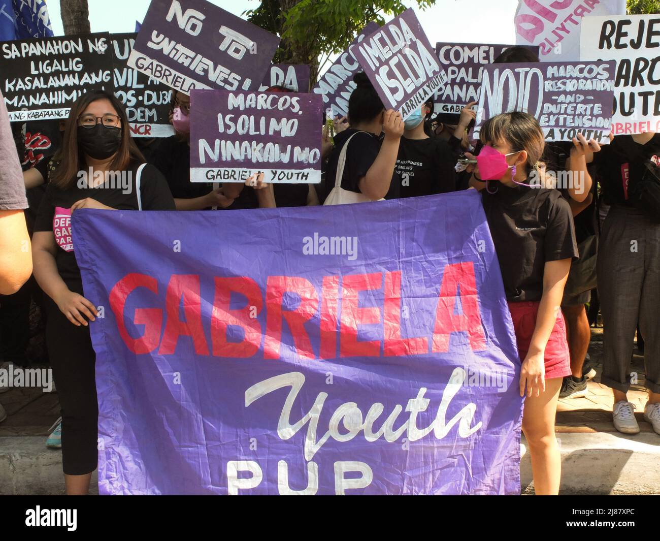GABRIELA women's group organization hold a banner and placards ...