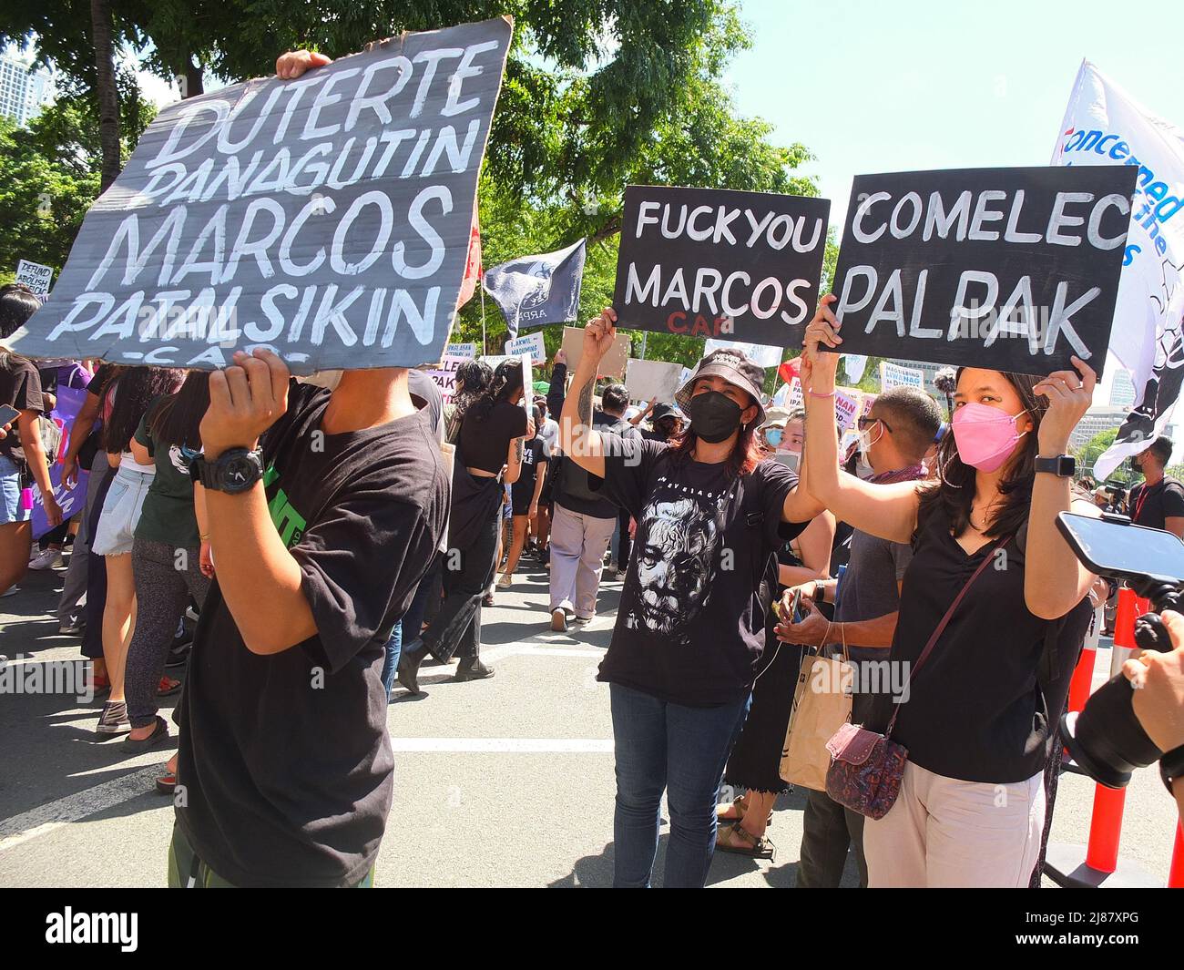 Protesters hold placards expressing their opinion during the ...