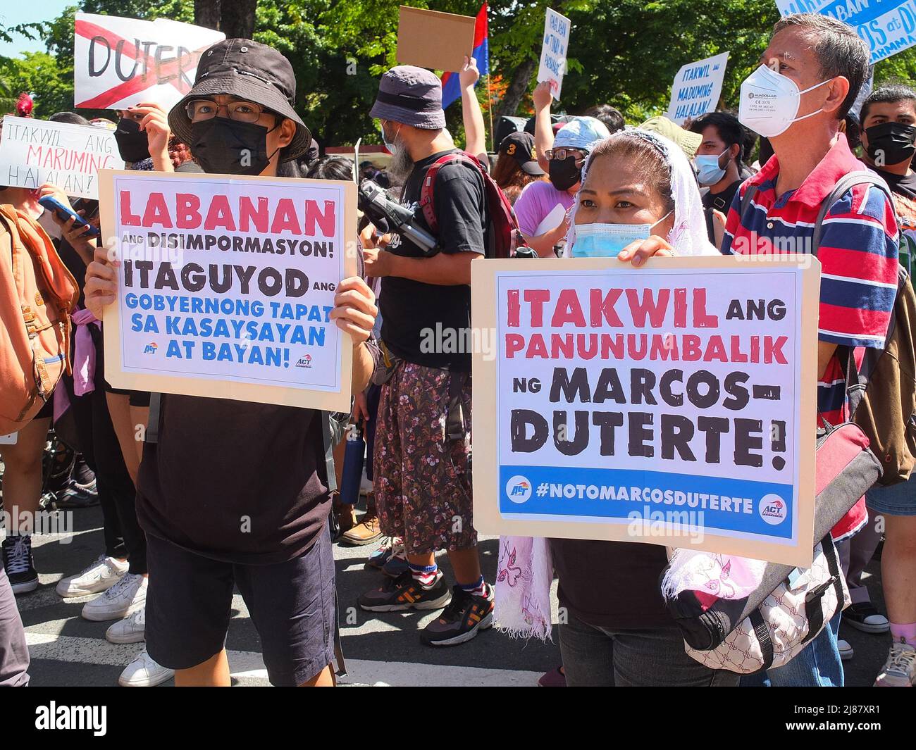 Protesters hold placards expressing their opinion during the ...